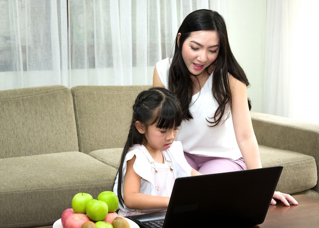 Premium Photo Asian Mom Is Teaching Their Daughter To Type The