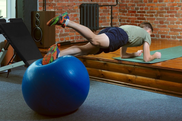 Premium Photo | Athletic man doing balancing exercises with the gym ball Premium Photo | Athletic man doing balancing exercises with the gym ball