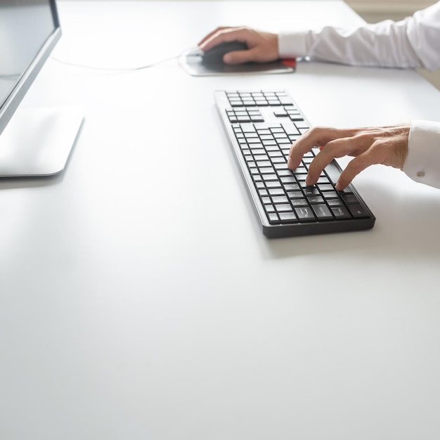 Premium Photo Computer Programmer Working Using His Office Computer Keyboard And Mouse As He