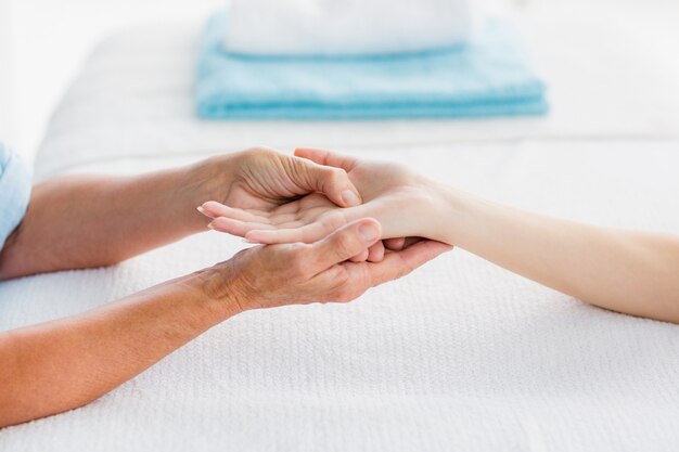 Premium Photo Midsection Of Masseur Giving Foot Massage To Woman