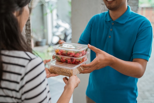 Premium Photo | Delivery man delivering food Premium Photo | Delivery man delivering food
