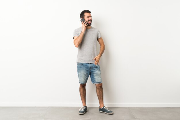 Premium Photo A Full Length Shot Of Handsome Man With Beard Keeping A