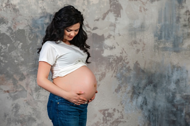 Close Up Of Pregnant Womans Big Hairy Belly On Bright Bokeh Lights Background Photo Free