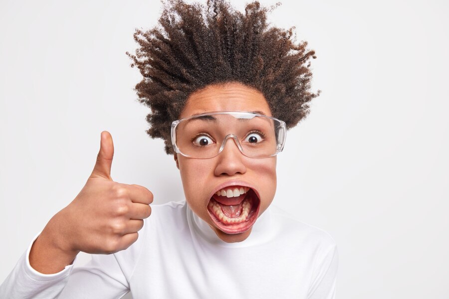 Free Photo Headshot Of Emotional Dark Skinned Woman Screams Loudly
