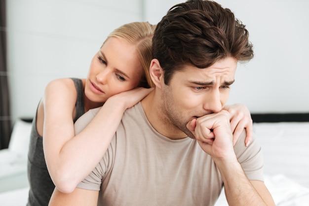 Free Photo Pretty Woman Comfort Her Sad Man While They Sitting In Bed