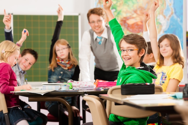Premium Photo | Pupils and teacher learning at school Premium Photo | Pupils and teacher learning at school