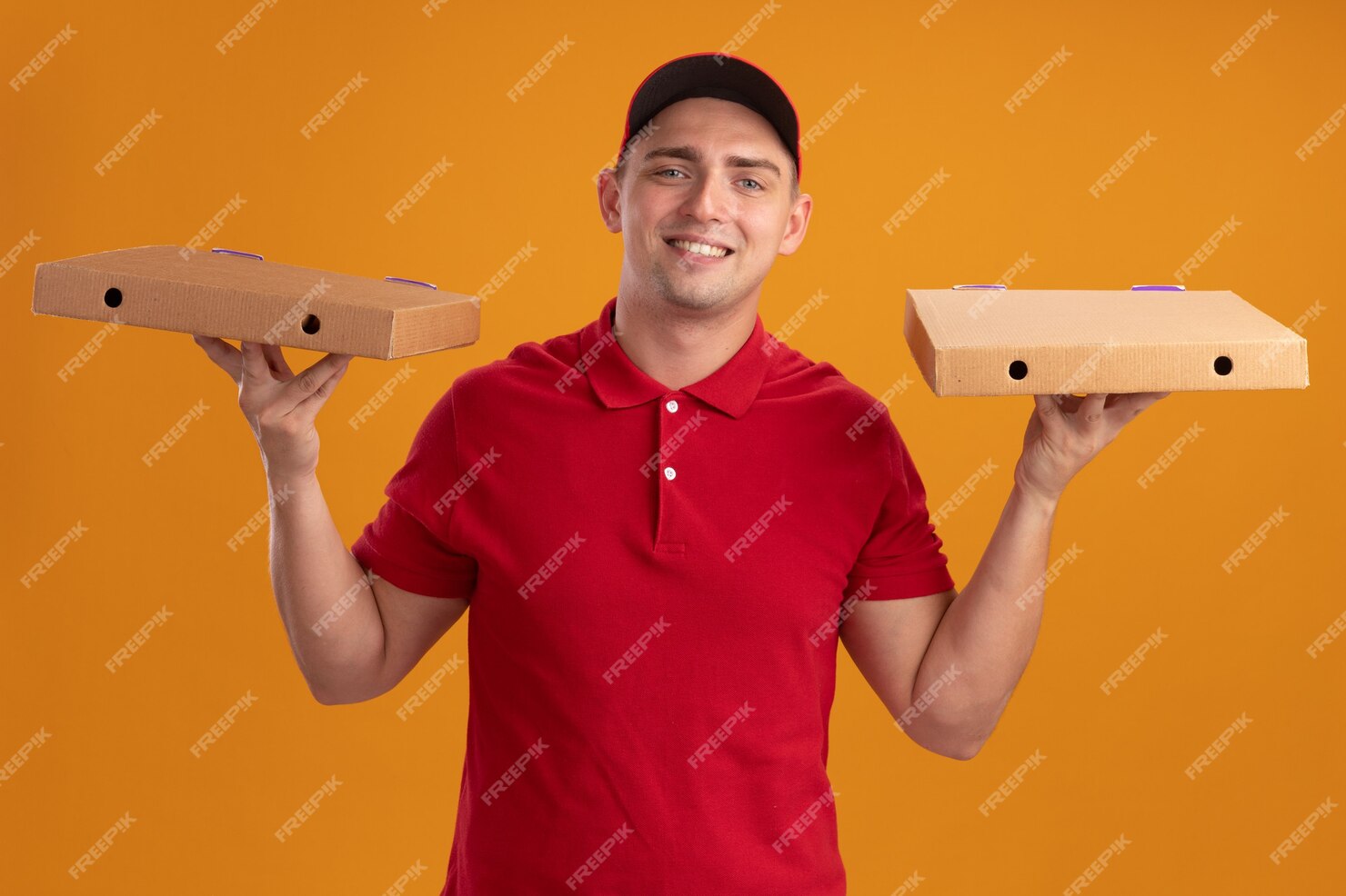Free Photo Smiling Young Delivery Man Wearing Uniform With Cap