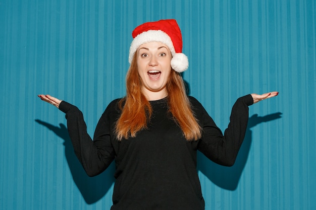 Free Photo Surprised Christmas Woman Wearing A Santa Hat