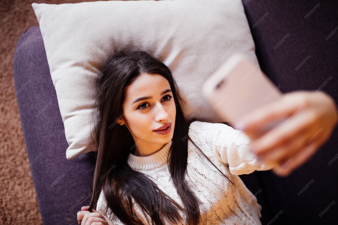 Free Photo Top View Of Sexy Brunette Taking A Selfie With Her Smart Phone At Home At White Pillow