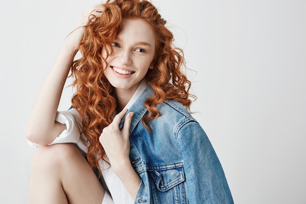 Free Photo Young Sincere Girl With Red Curly Hair Smiling Looking In