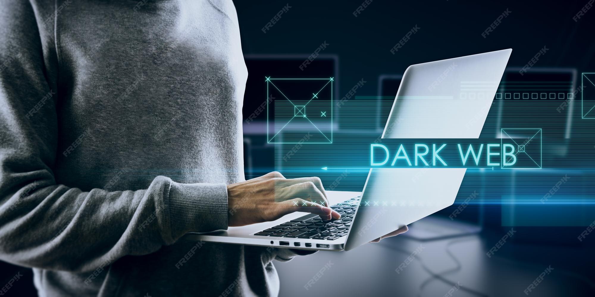 Premium Photo | Abstract dark web text over hacker holding and using notebook computer on blurry ...
