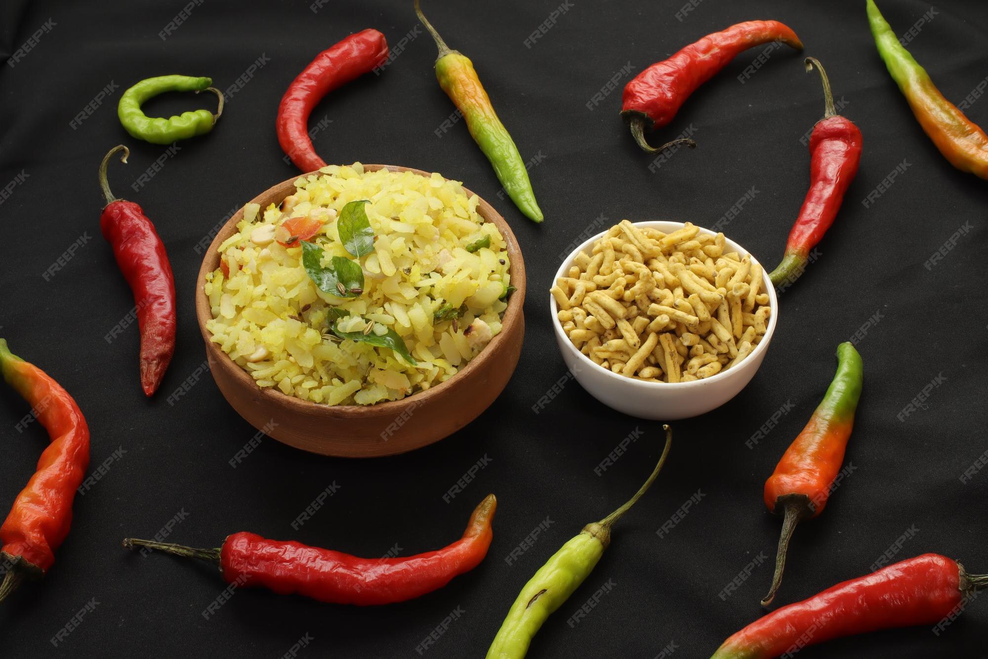 Premium Photo Aloo Kanda Poha With Sev Surrounded By Red And Green Chilli Famous Indori Sev