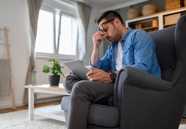 Premium Photo Anxious Male Computer Programmer With Headache Working On Laptop