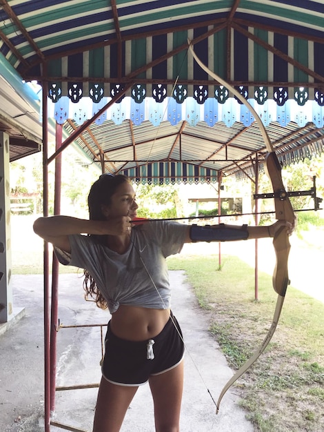 Premium Photo | Archery aiming with bow Premium Photo | Archery aiming with bow