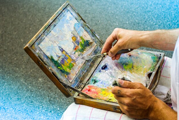 Premium Photo | Artist drawing oil painting on a wooden canvas Premium Photo | Artist drawing oil painting on a wooden canvas