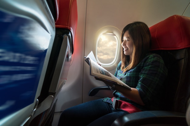 Premium Photo Asia Young Woman Reading The Magazine While Traveling