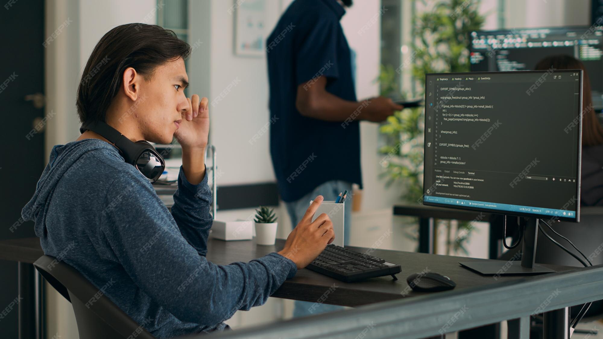 Premium Photo | Asian database programer writing code on computer displaying artificial ...