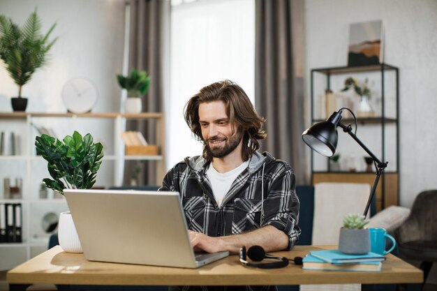Premium Photo Beautiful Caucasian Bearded Man Sitting At Desk And