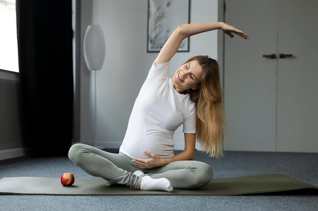 Premium Photo Beautiful Smiling Pregnant Woman Stretching Doing