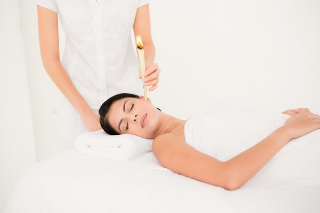 Premium Photo Beautiful Woman Receiving Ear Candle Treatment At Spa
