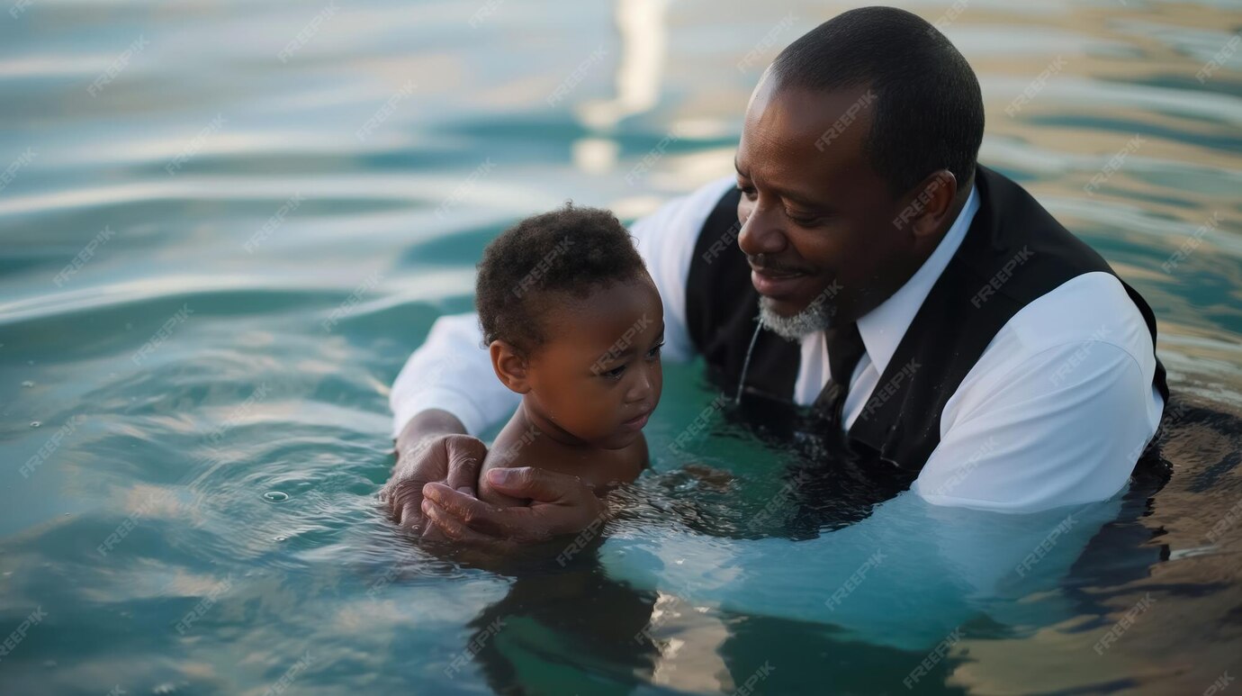 Black pastor baptizes young black child in water surrounded by serene ... Black pastor baptizes young black child in water surrounded by serene ...
