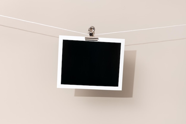 Premium Photo | Blank Vintage instant photo frame hanging on a rope Premium Photo | Blank Vintage instant photo frame hanging on a rope