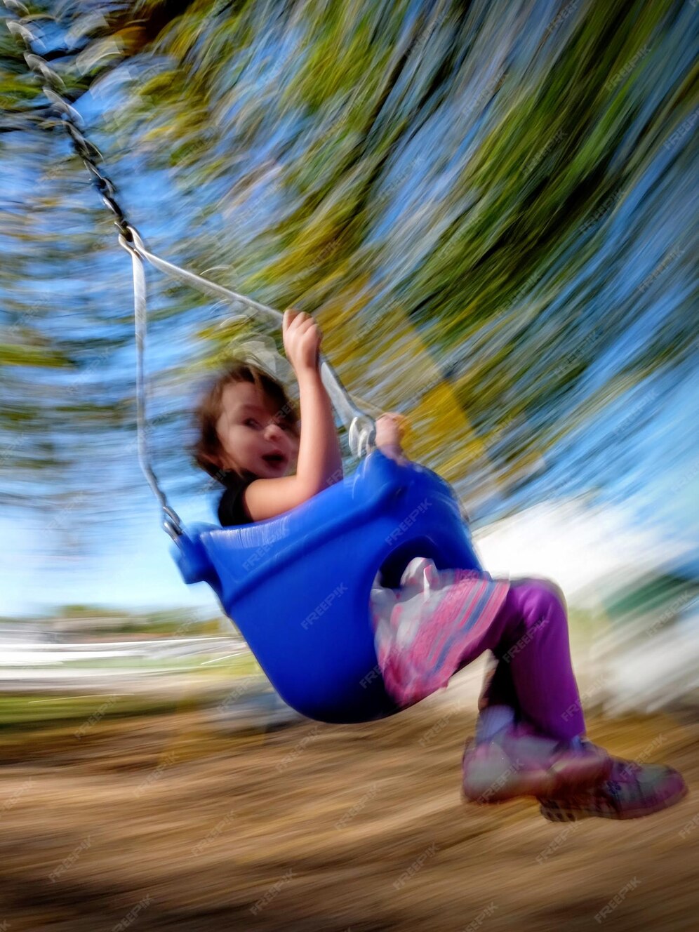 Premium Photo Blurred Motion Of Girl Sitting On Swing In Playground