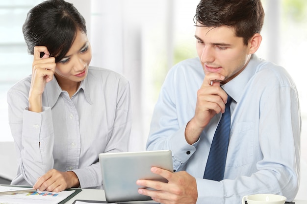 Premium Photo | Business partners using touchpad at meeting Premium Photo | Business partners using touchpad at meeting
