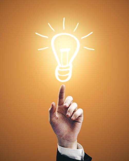 Premium Photo | Businessman hand pointing to drawing light bulb Premium Photo | Businessman hand pointing to drawing light bulb