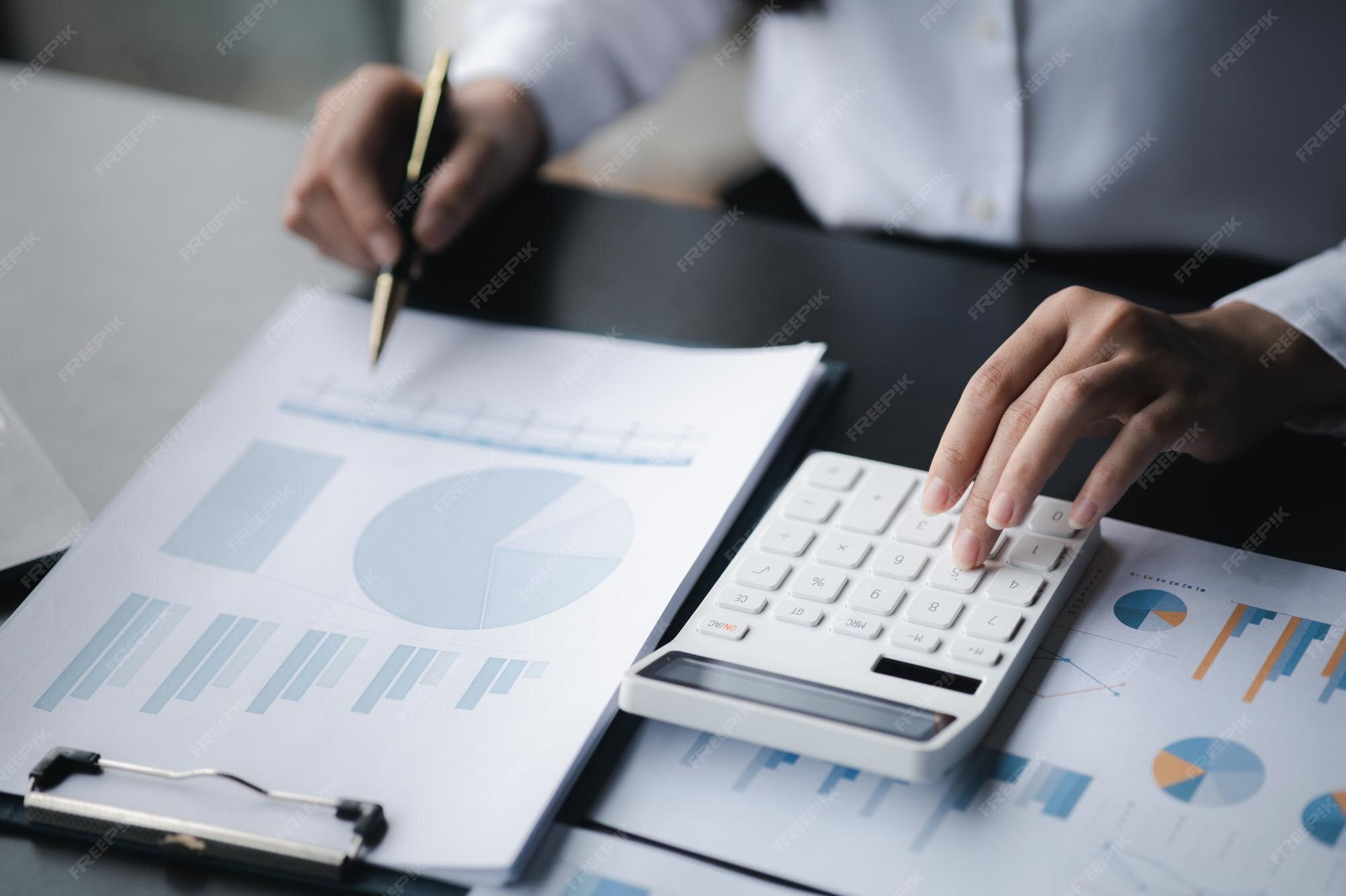 Premium Photo | Businessman is using a calculator to calculate company ... Premium Photo | Businessman is using a calculator to calculate company ...