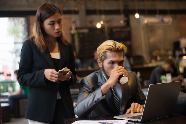 Premium Photo | Businesswoman using mobile phone while colleague at cafe Premium Photo | Businesswoman using mobile phone while colleague at cafe