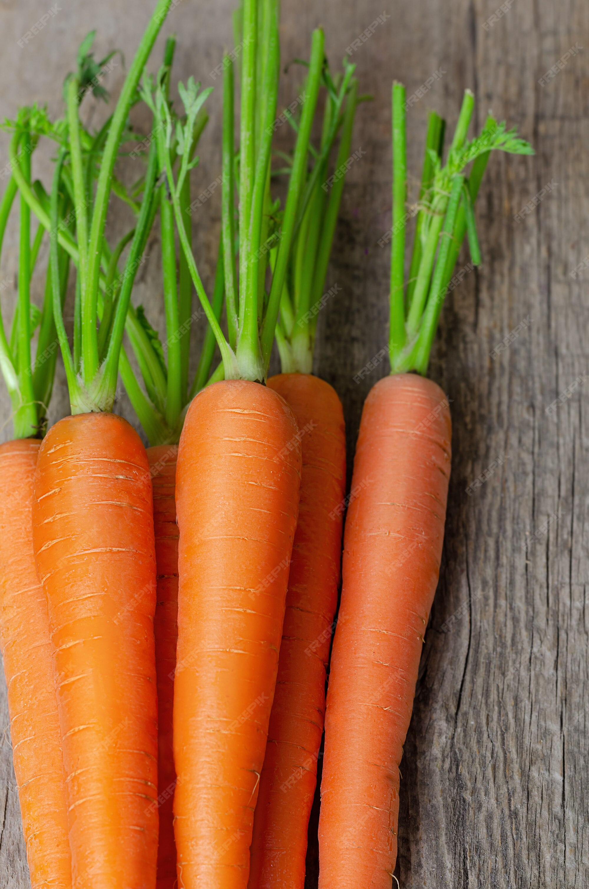 Premium Photo | Carrot bunch on wooden table Premium Photo | Carrot bunch on wooden table
