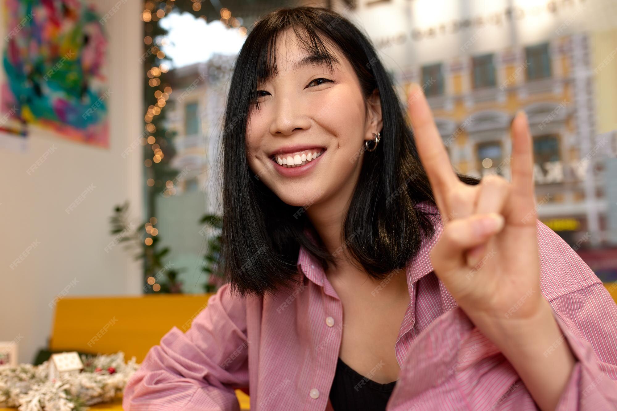 Premium Photo Cheerful Asian Woman Showing Thumbs Up Positive Mood