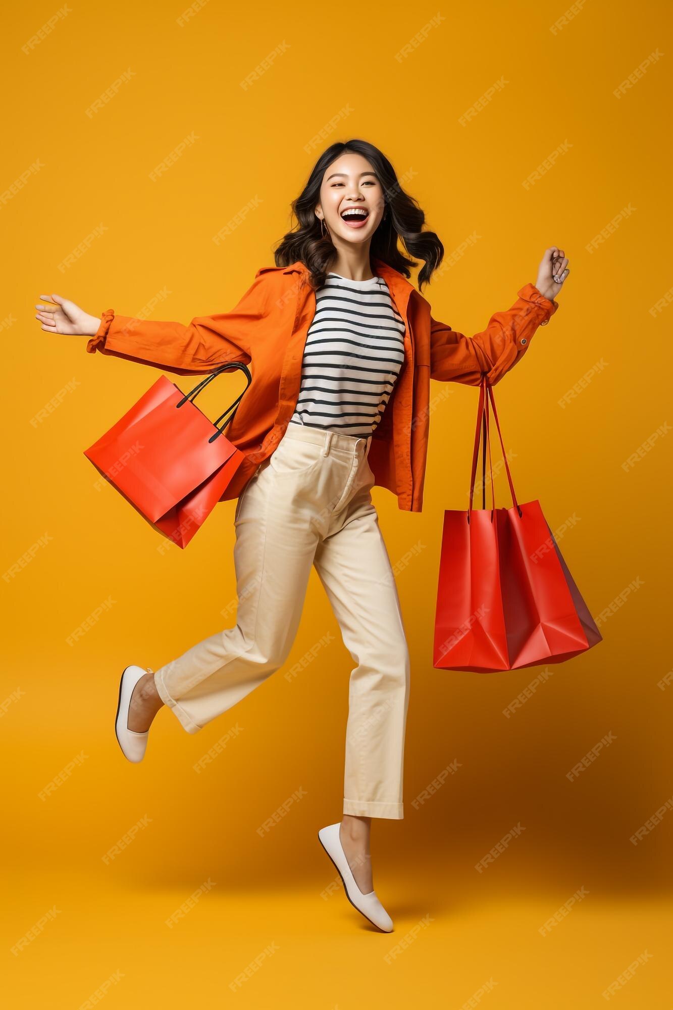 Premium Photo Cheerful Beautiful Asian Woman Holding Multi Coloured