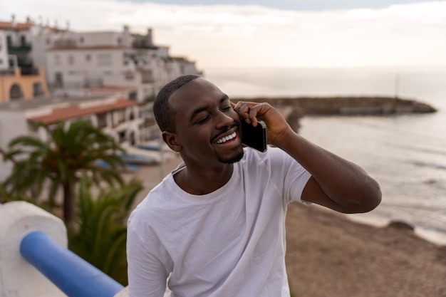 Premium Photo | Cheerful black man talking on cellphone at beach Premium Photo | Cheerful black man talking on cellphone at beach