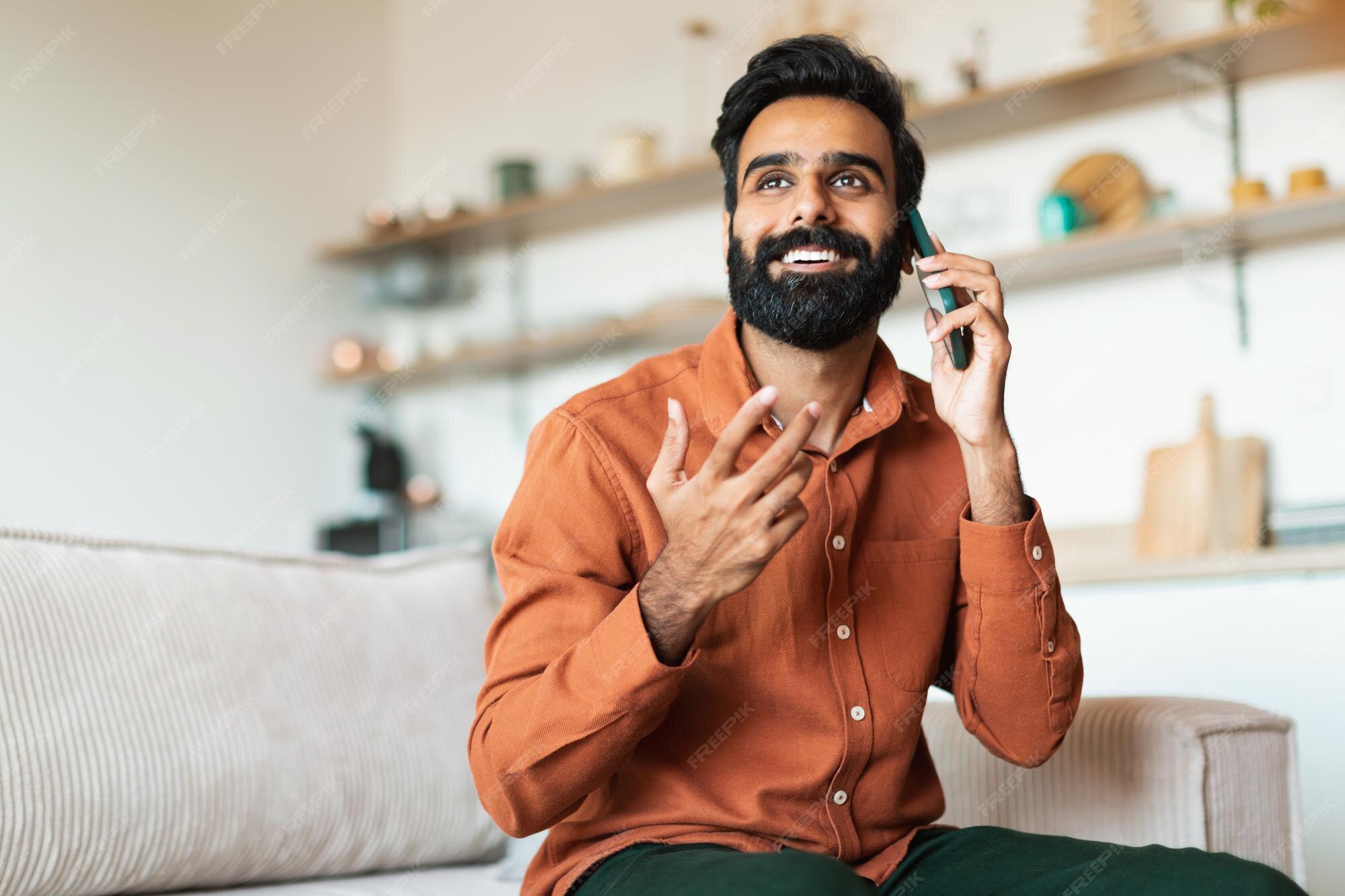Premium Photo | Cheerful handsome arab guy talking on cellphone in ... Premium Photo | Cheerful handsome arab guy talking on cellphone in ...