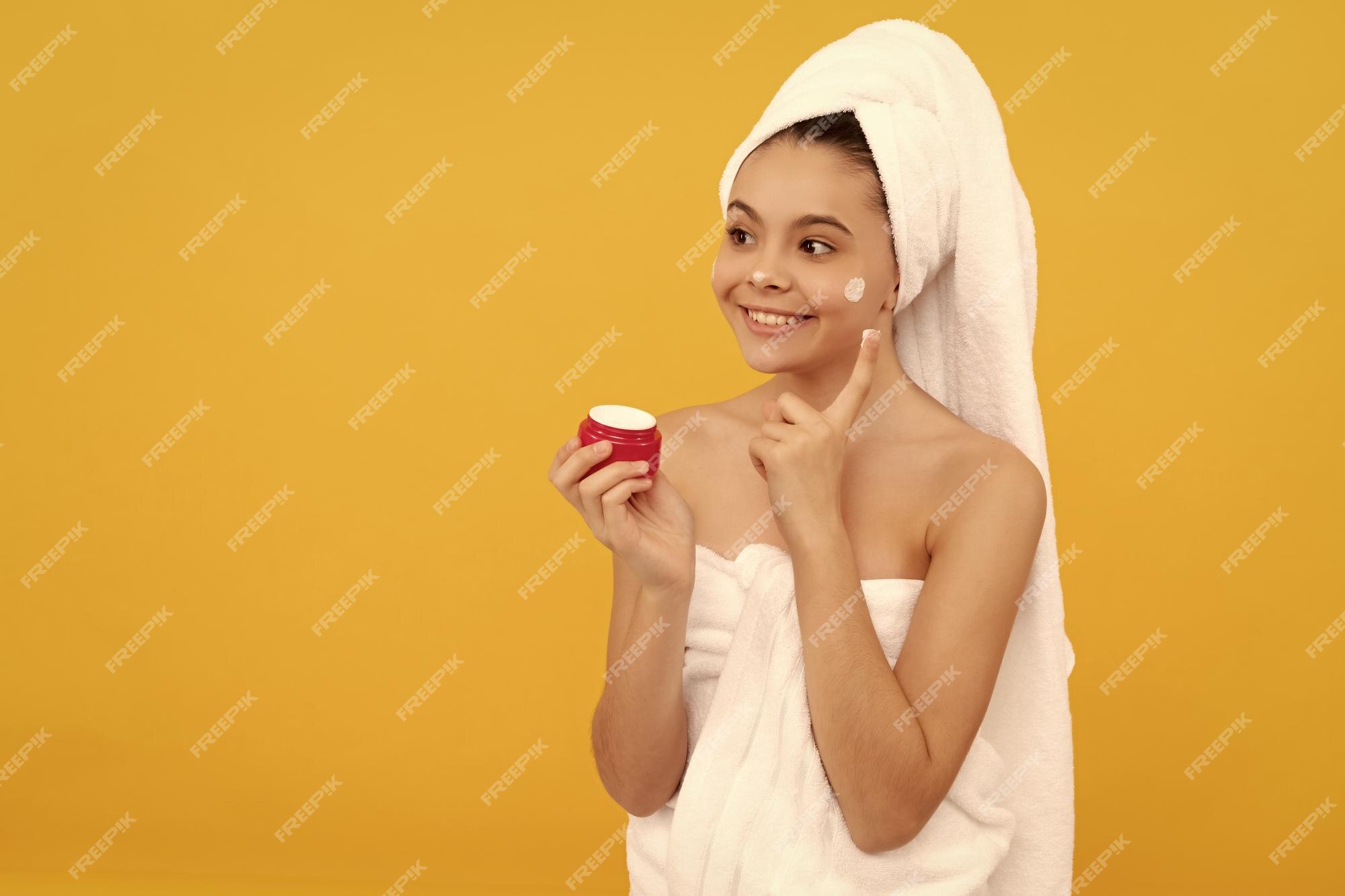 Premium Photo Cheerful Teen Girl In Shower Towel Apply Facial Cream