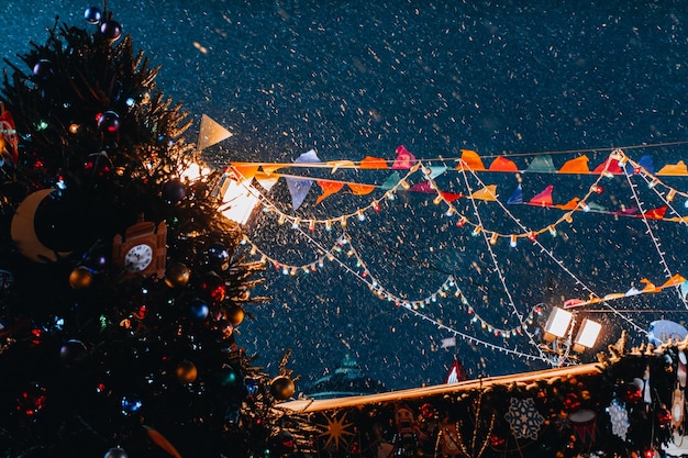 Premium Photo | Christmas tree and flying snow in the evening light in ... Premium Photo | Christmas tree and flying snow in the evening light in ...
