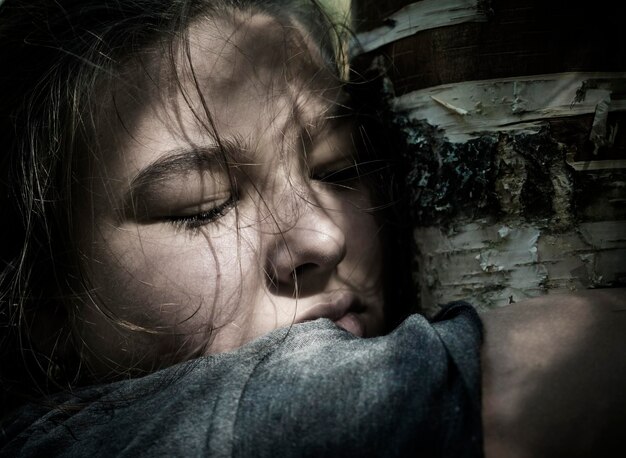 Premium Photo Close Up Of Girl Embracing Tree Trunk