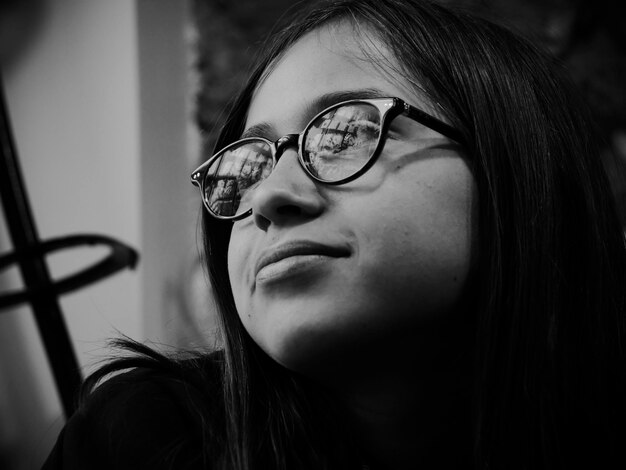 Premium Photo Close Up Of Girl Wearing Eyeglasses Looking Away