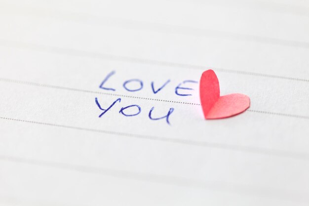 Premium Photo | Close-up of love you text by heart shape on paper Premium Photo | Close-up of love you text by heart shape on paper