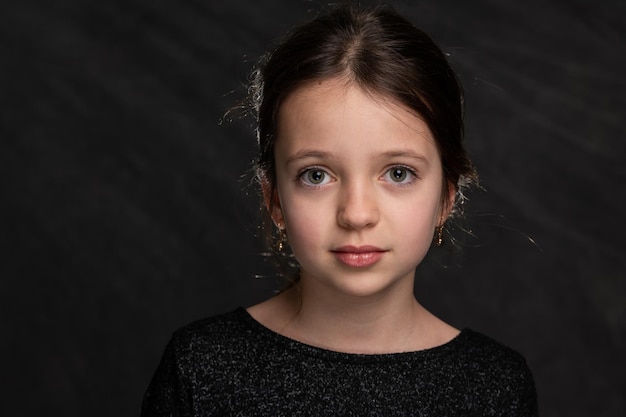 Premium Photo Close Up Portrait Of Innocent Girl Against Black Background