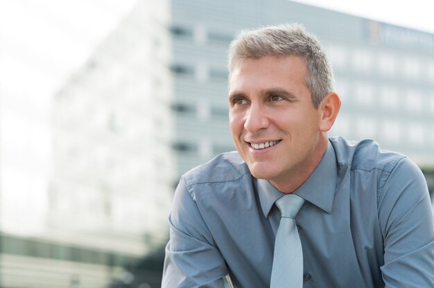 Premium Photo | Closeup of smiling mature businessman outdoor Premium Photo | Closeup of smiling mature businessman outdoor