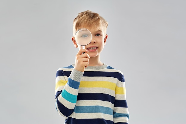 Premium Photo | Curious boy looking through magnifying glass Premium Photo | Curious boy looking through magnifying glass