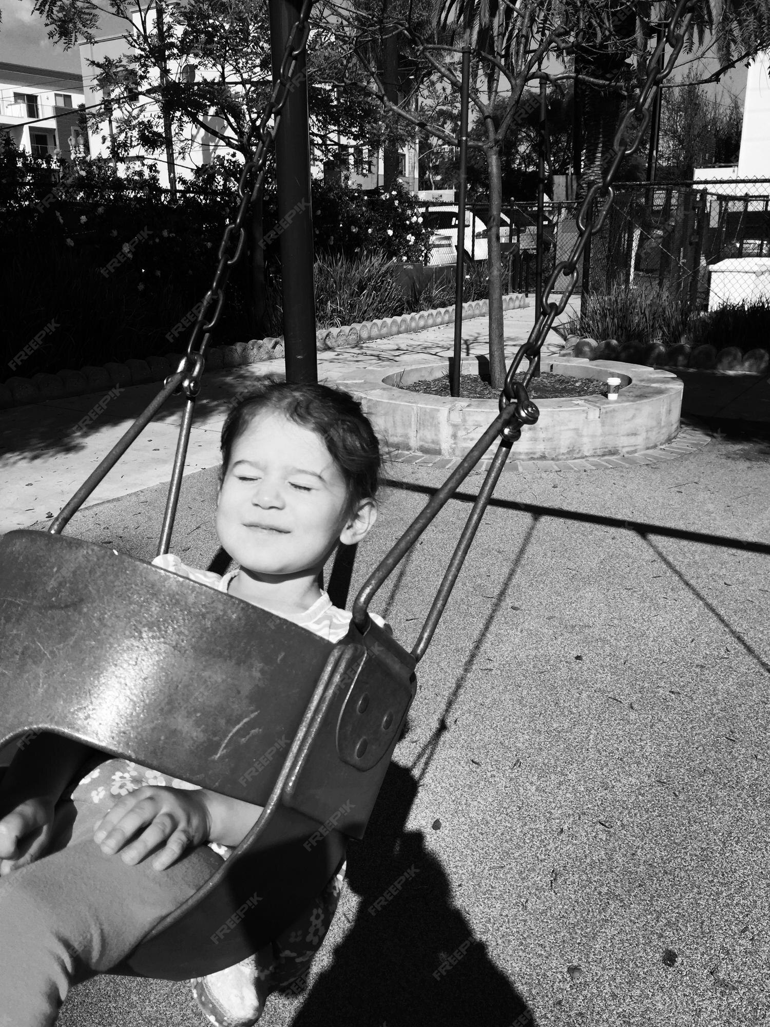 Premium Photo Cute Happy Girl Enjoying On Swing On Playground