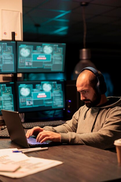 Premium Photo Dangerous Coder Hacking Security System To Steal Big Data Wearing Headphones At