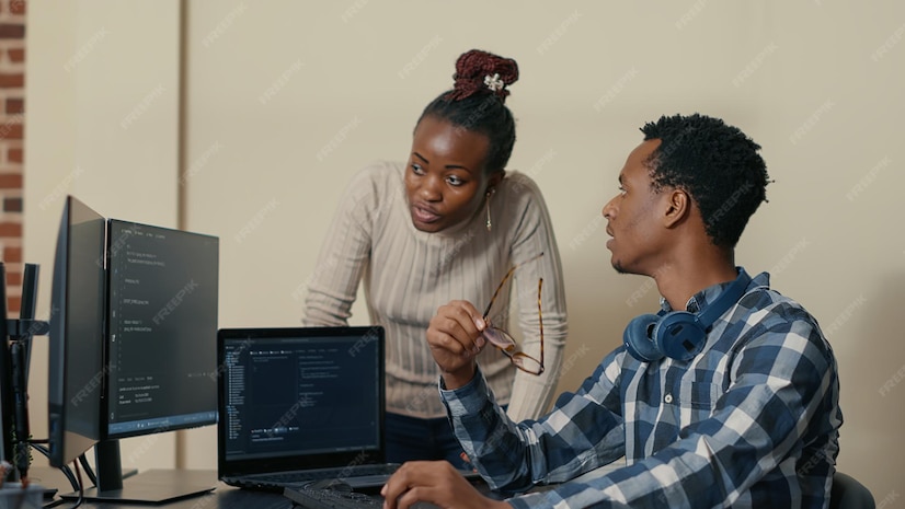 Premium Photo | Database developer removing glasses while explaining algorithm to colleague ...