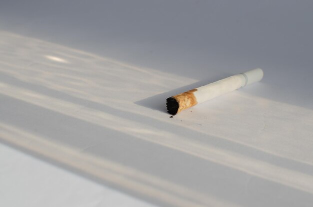 Premium Photo | Detail of cigarettes on a white surface symbolizing the ... Premium Photo | Detail of cigarettes on a white surface symbolizing the ...