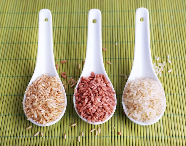 Premium Photo | Different types of rice in spoons on bamboo background Premium Photo | Different types of rice in spoons on bamboo background