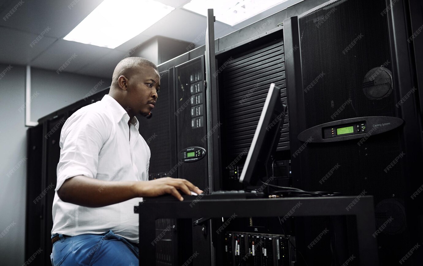 Premium Photo | Engineer black man or coding on laptop in server room ...